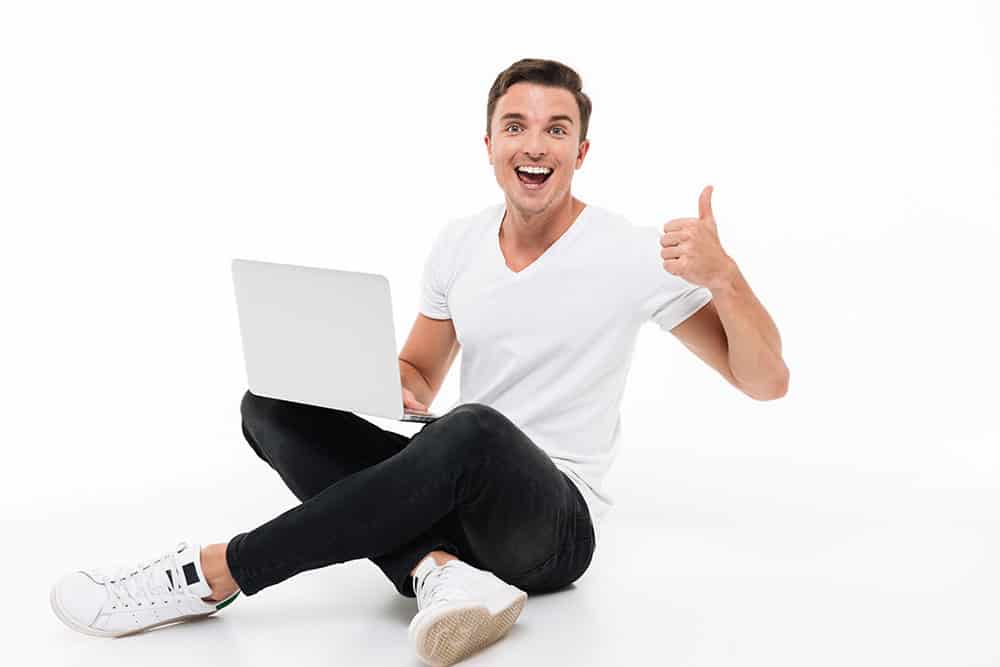 Portrait of a happy excited man holding laptop computer - Agenzia web ...
